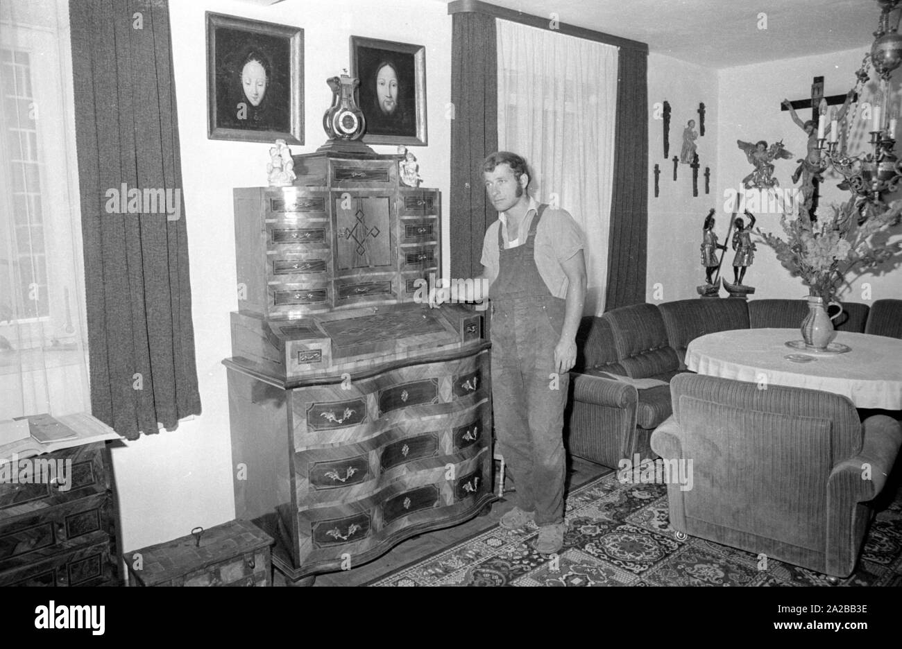 A carpenter is posing next to the newly completed dresser Stock Photo ...