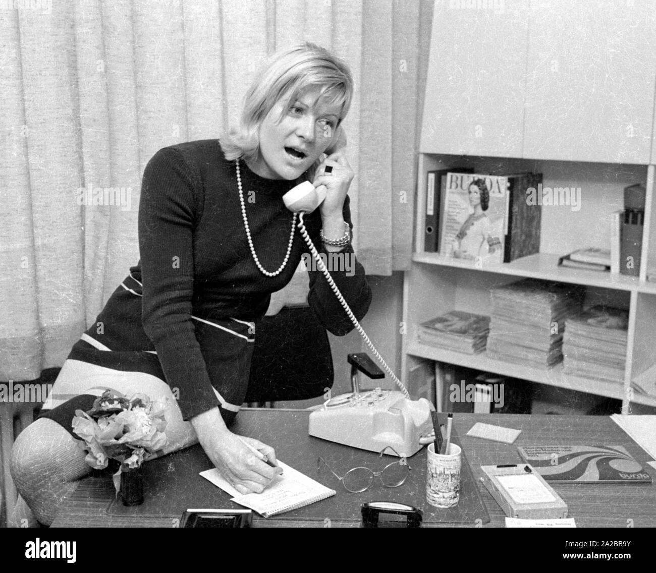 A secretary leads a telephone conversation at the desk Stock Photo - Alamy