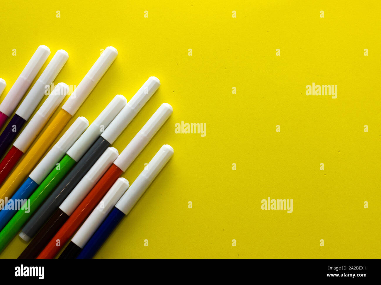 Collection of colored felt pen on a yellow background top view and copy ...