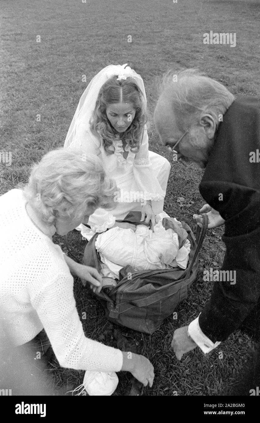 The bride with parachute for her wedding on the Schliersbergalm after ...