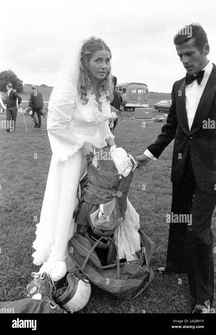 The bride and groom get ready for the parachute jump and their ...