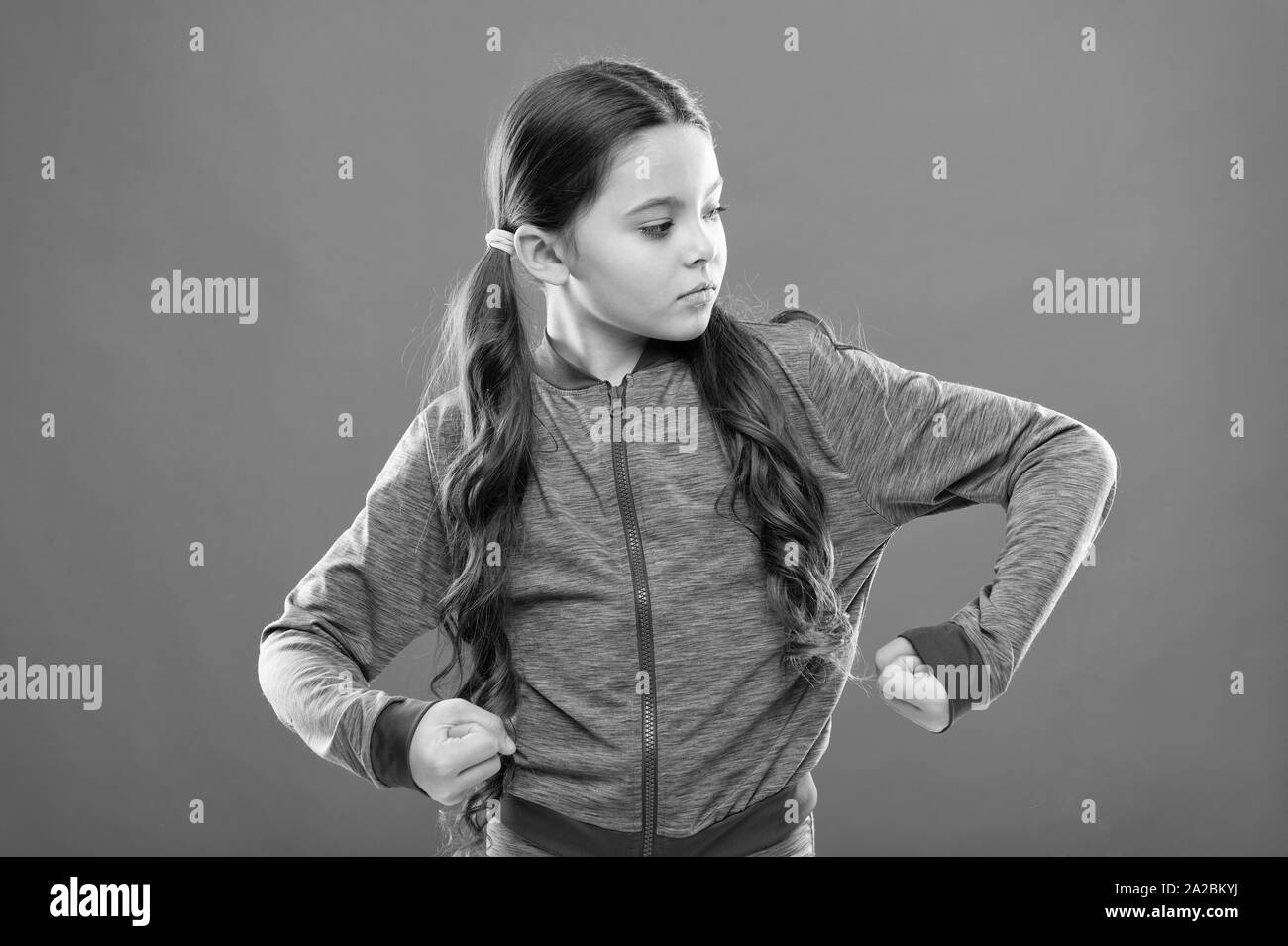 Satisfied with her strong healthy body. Feeling strong. Child cute girl ...