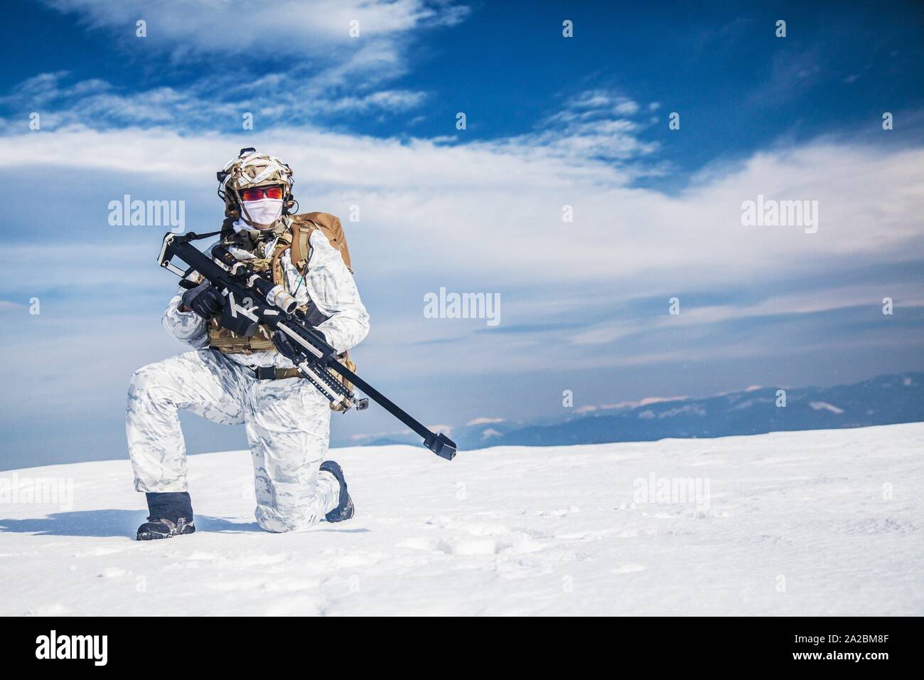 Army soldier with Sniper rifle in action in the Arctic. He wears chest ...