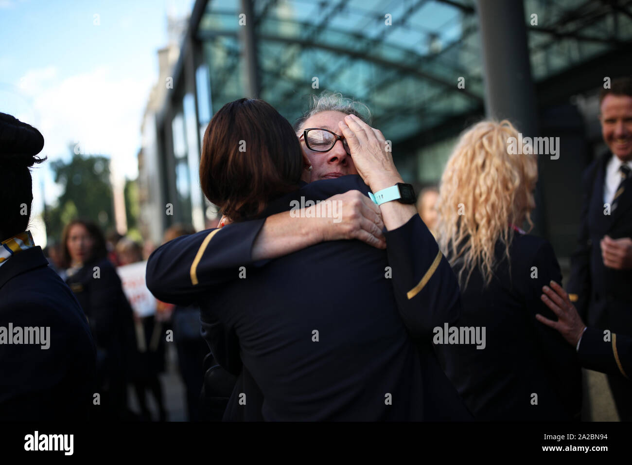Ex-Thomas Cook employees console each other during a protest outside ...