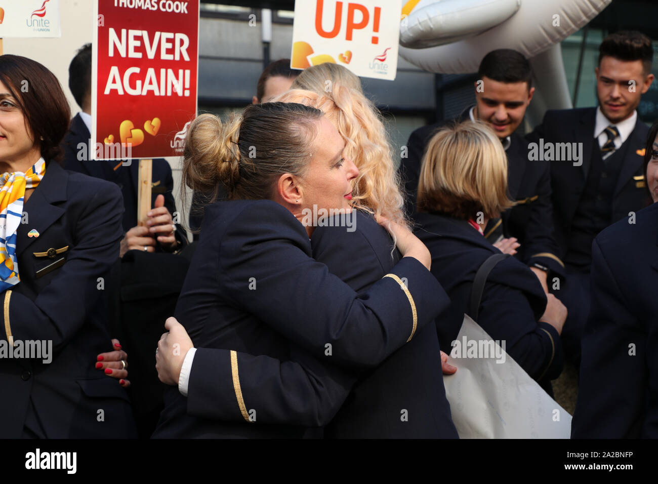 Ex-Thomas Cook employees console each other during a protest outside ...