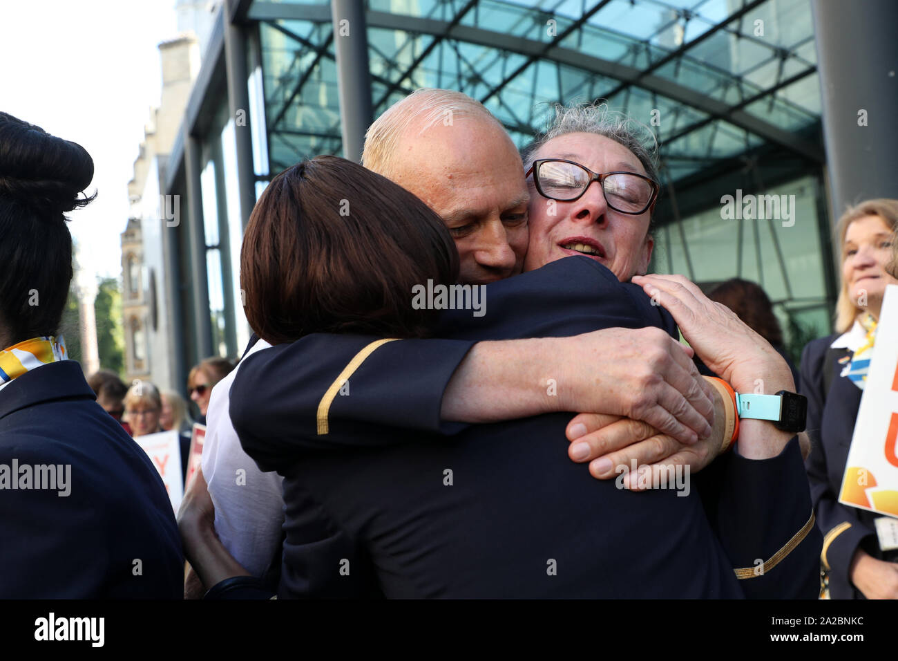 Ex-Thomas Cook employees console each other during a protest outside ...