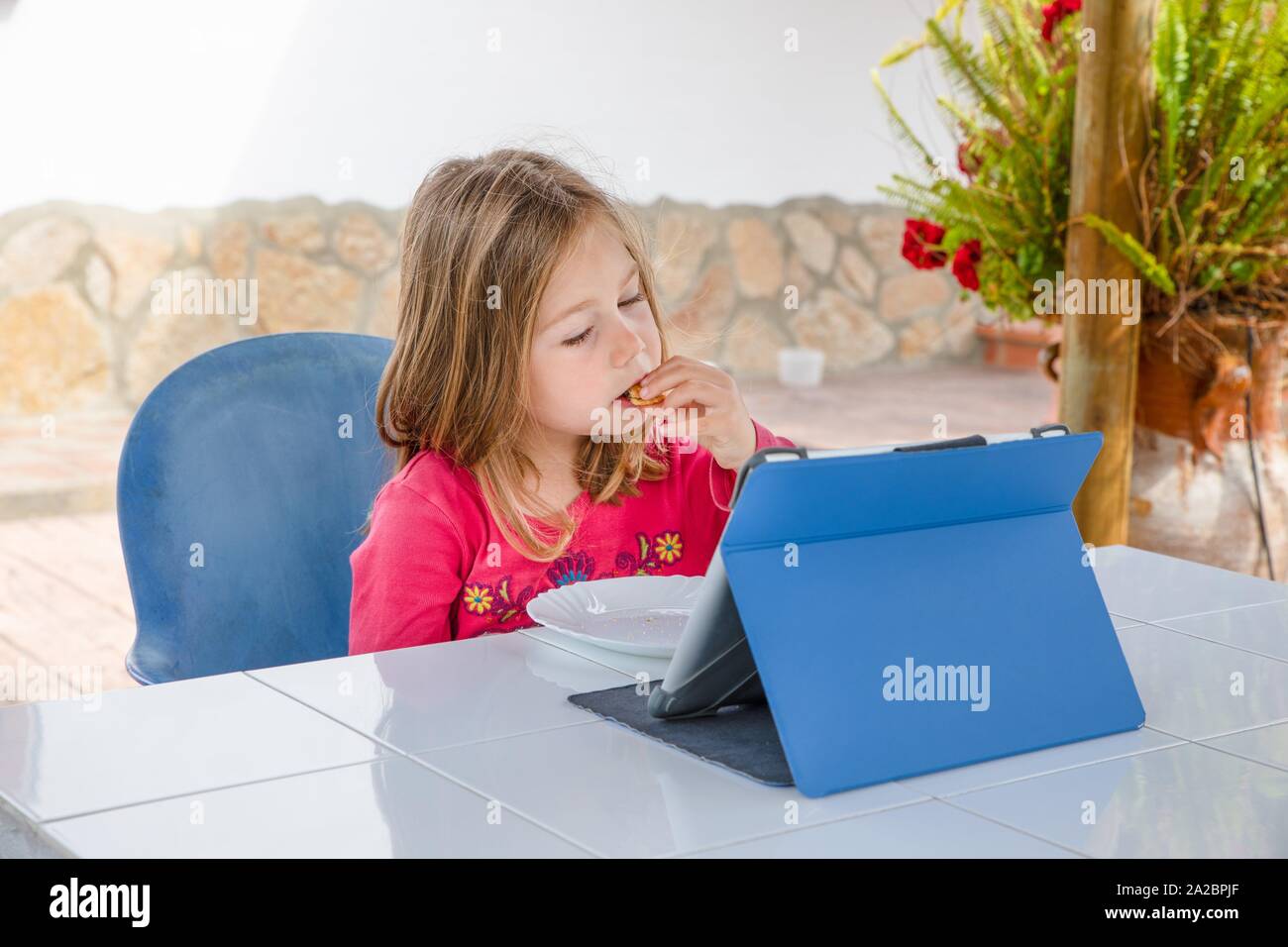 Child tablet table eating hi-res stock photography and images - Alamy