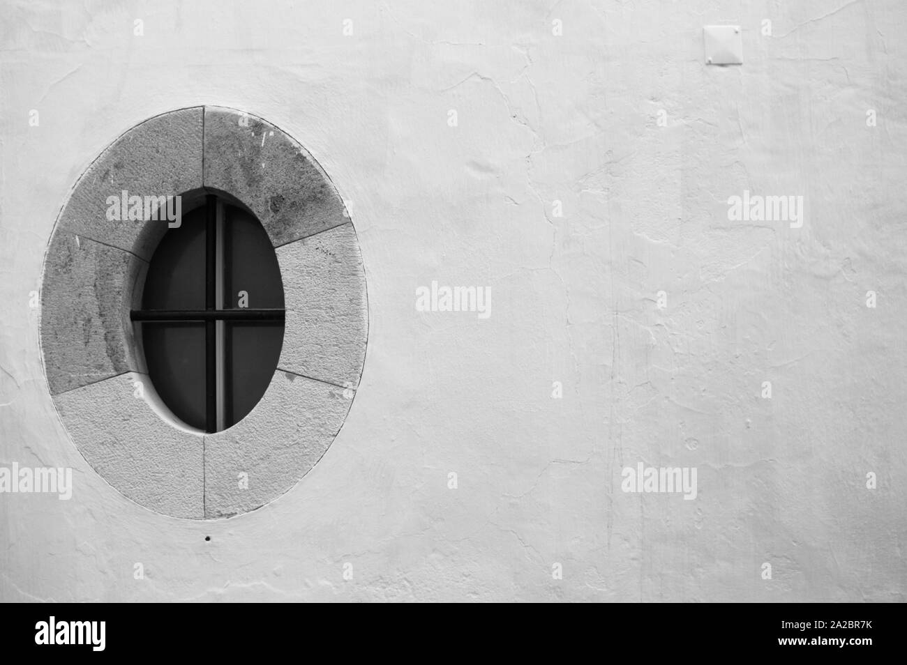 Medieval oval window isolated in a white wall background (Madeira ...