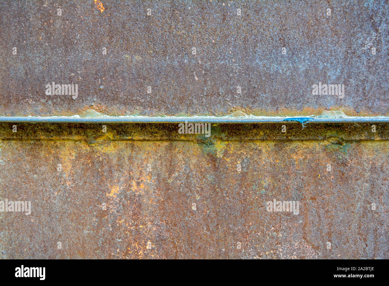 Detail of rusty corroded metal flat shutter or door. Old red metal ...