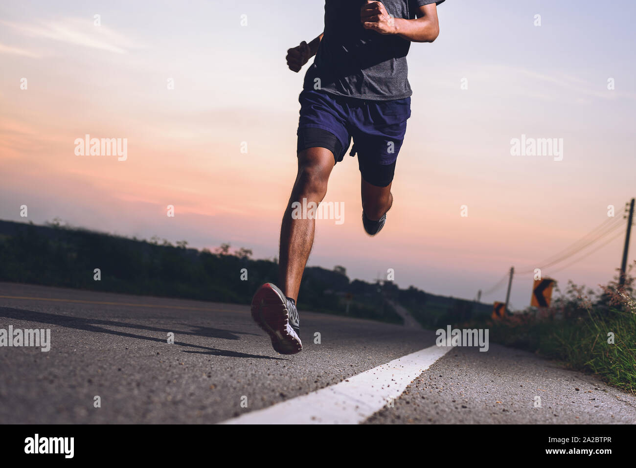 Athlete runner feet running on road, Jogging concept at outdoors. Man ...