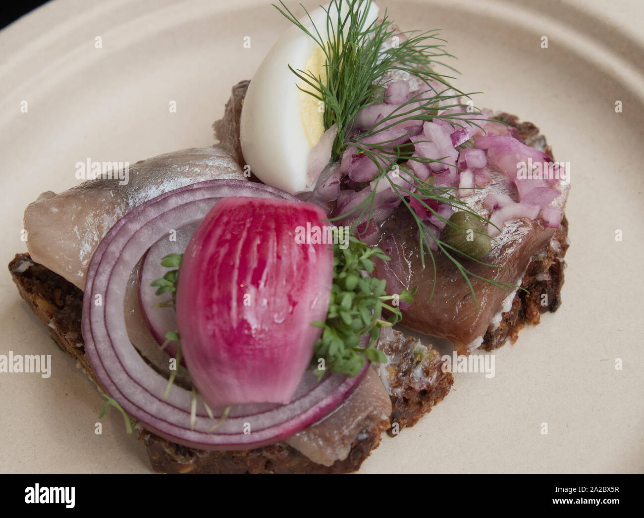 Pickled herring smorrebrod inside the Torvehallerne indoor market in ...