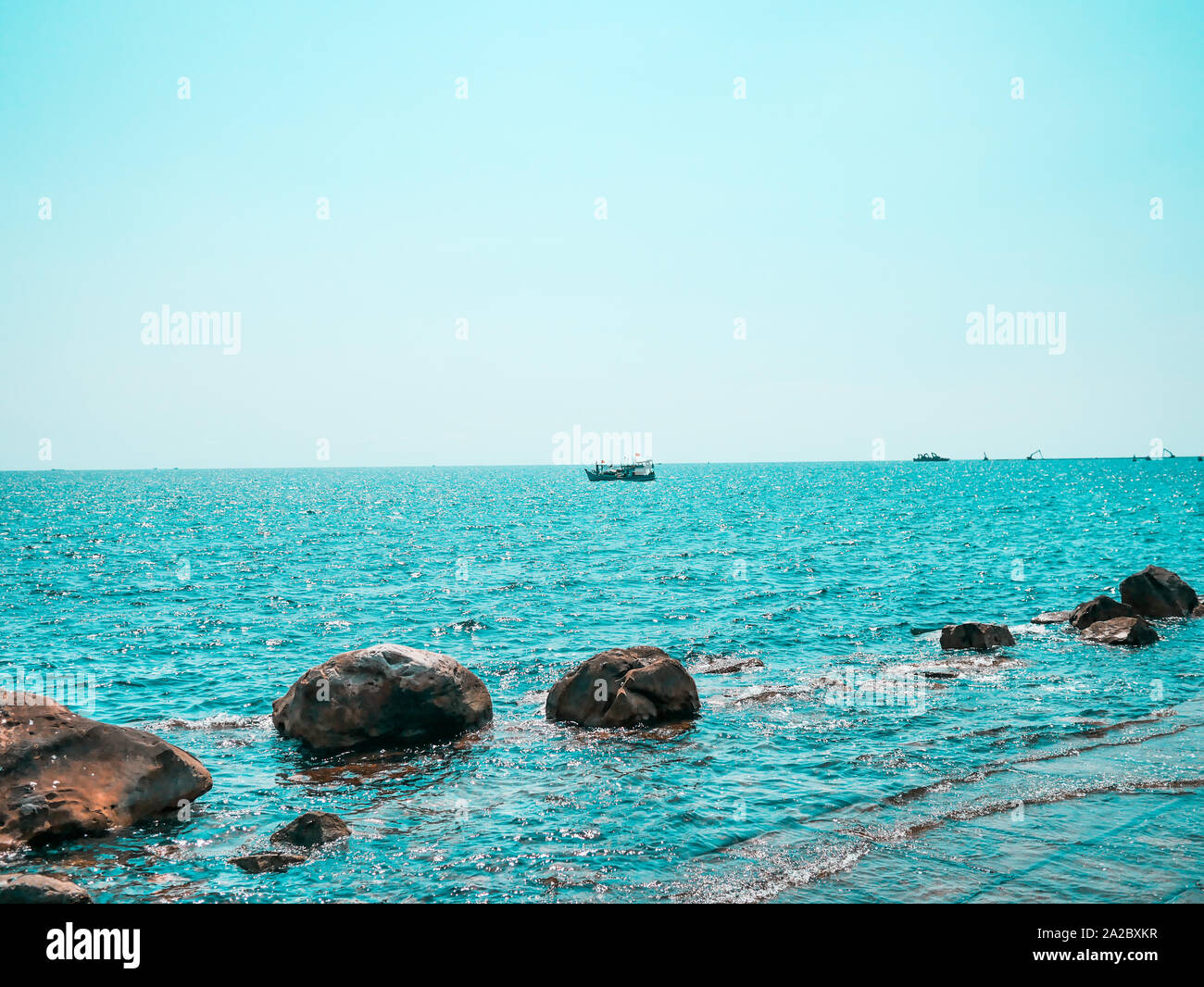 Beautiful ocean view with boat far away and cyan blue sky in VIetnam ...