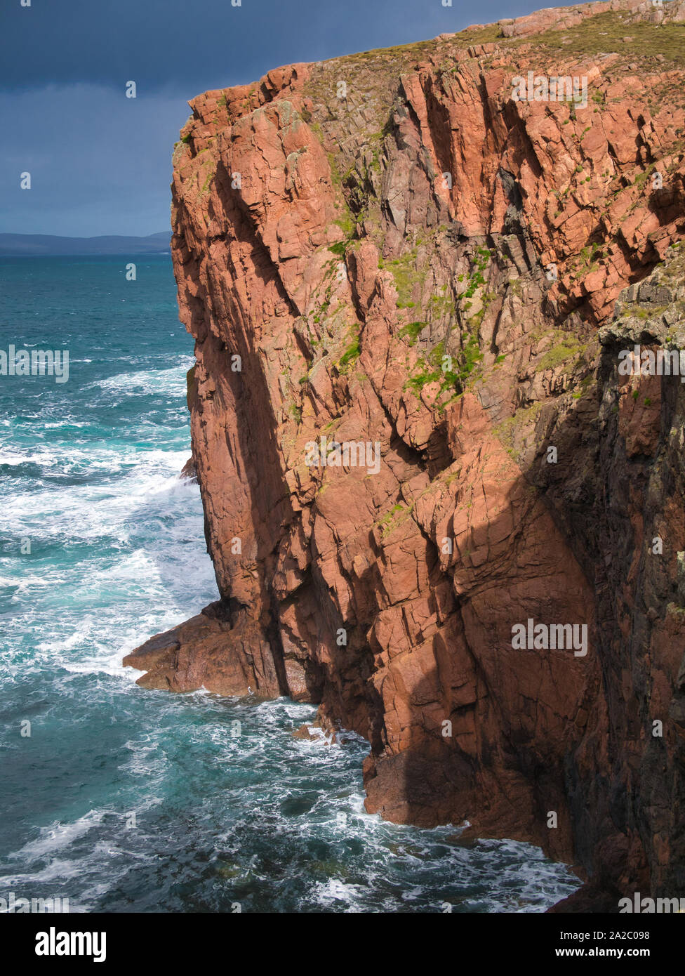 Sea cliffs near North Ham on Muckle Roe, Shetland, UK - the rock is of ...