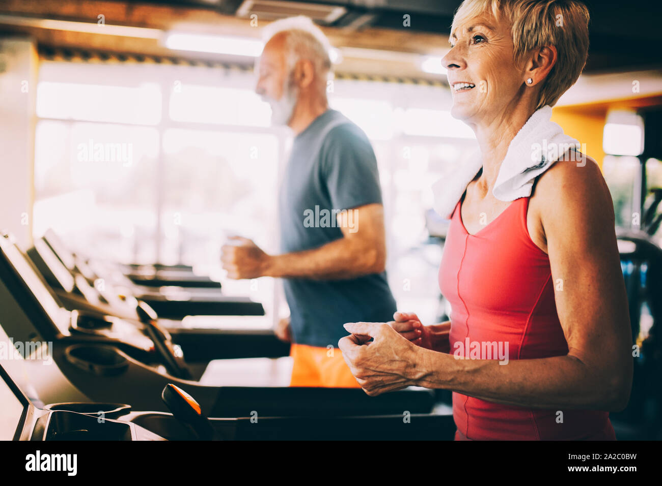 Senior people running in machine treadmill at fitness gym club Stock ...
