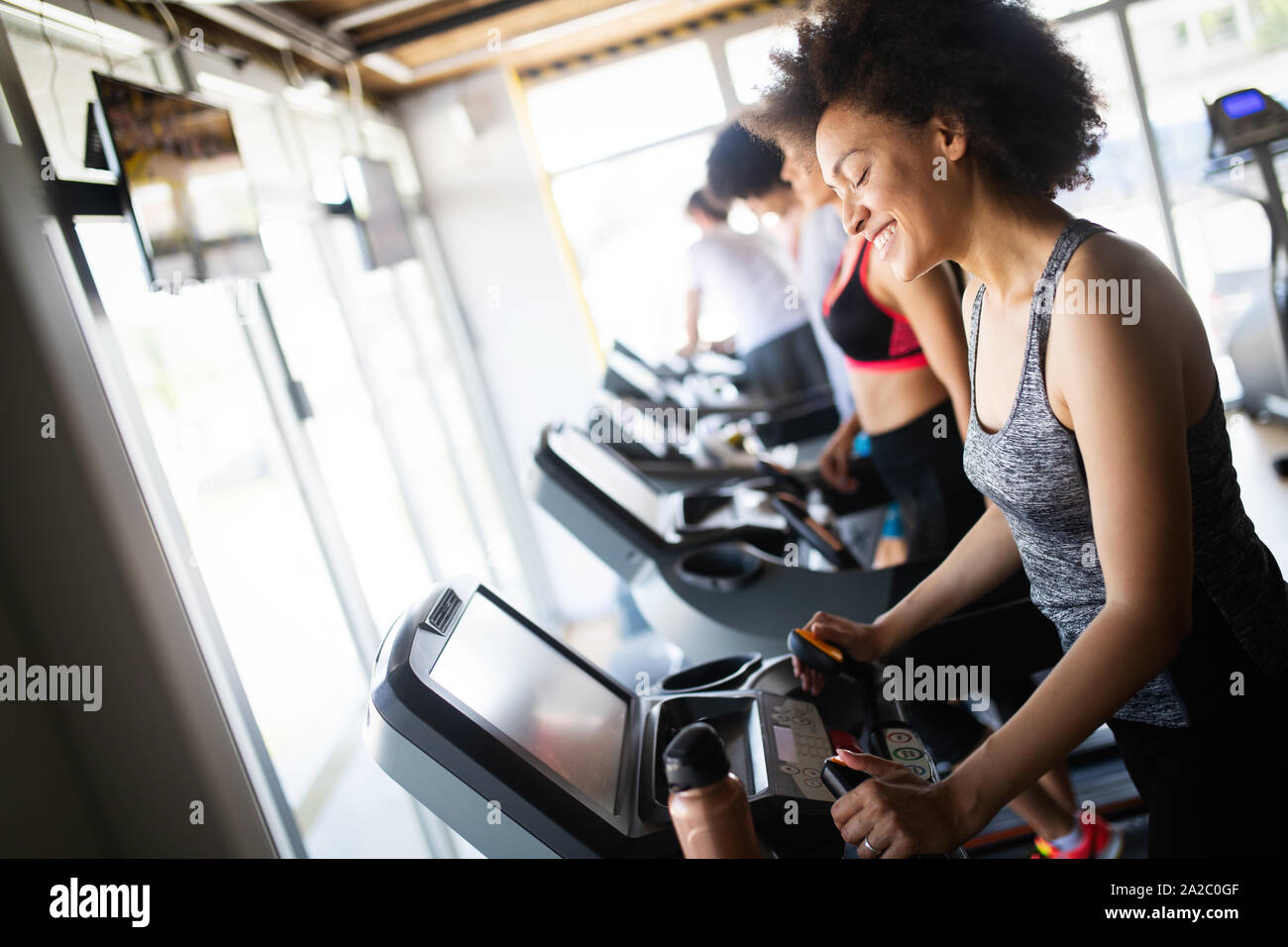 Fit people running in machine treadmill at fitness gym Stock Photo - Alamy