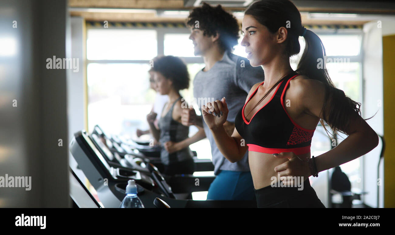 Group of fit healthy friends people cardio workout in gym Stock Photo ...