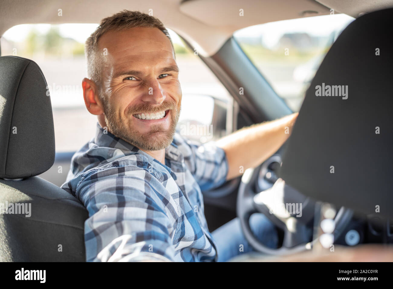 Attractive man driving a car Stock Photo - Alamy