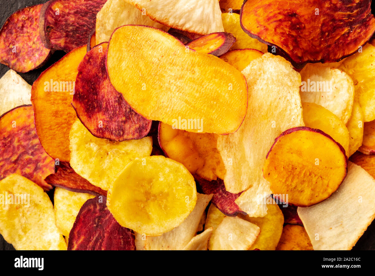 A close-up of dry fruit and vegetable chips, healthy vegan snack, a ...