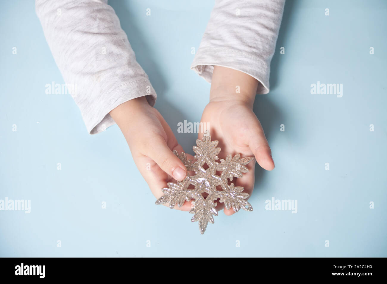 Girl's hand holding a Christmas decor big snowflake in a hands on the ...