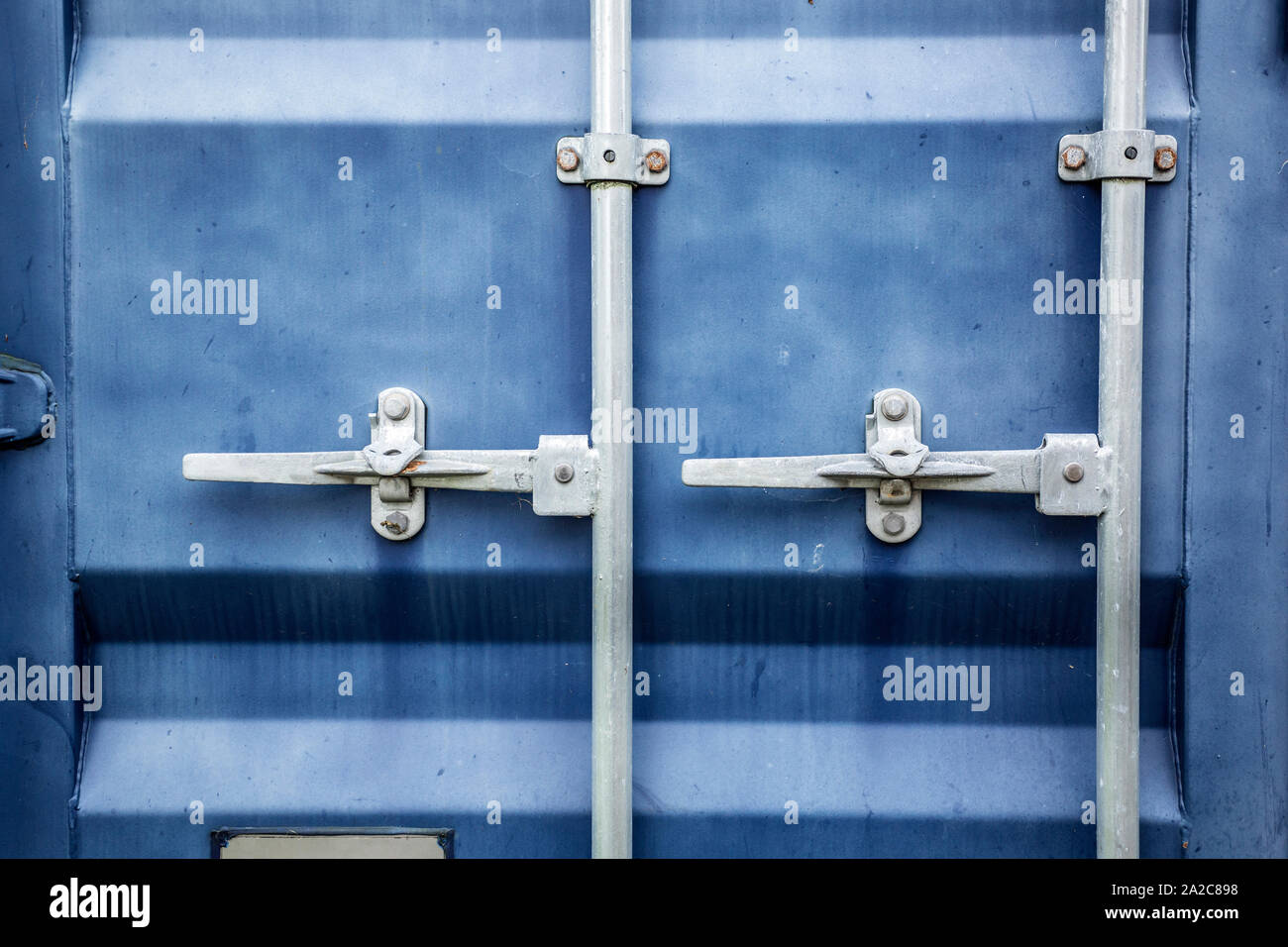 Blue metal door on a large shipping container Stock Photo - Alamy