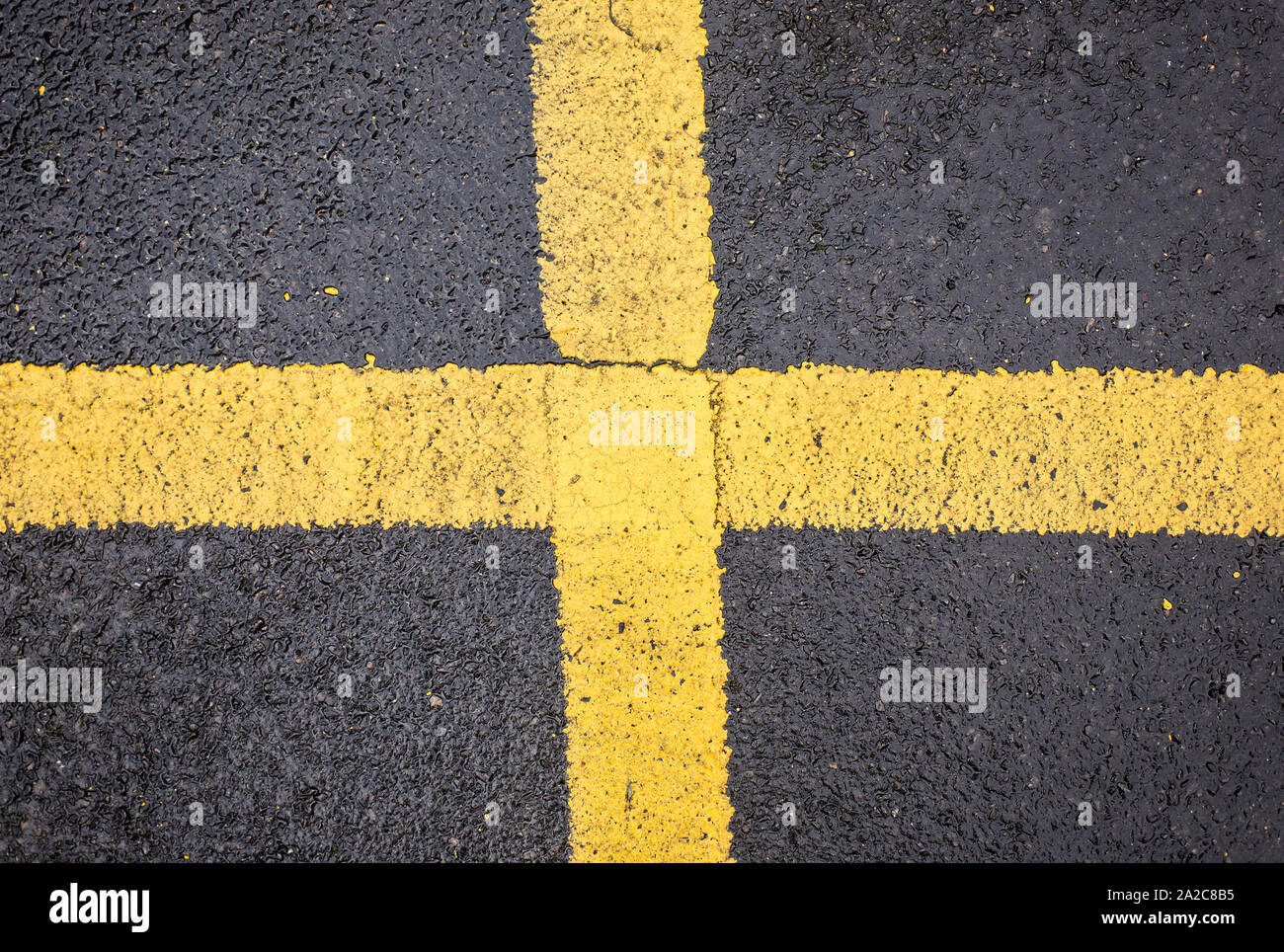 Bright yellow cross on road floor Stock Photo - Alamy