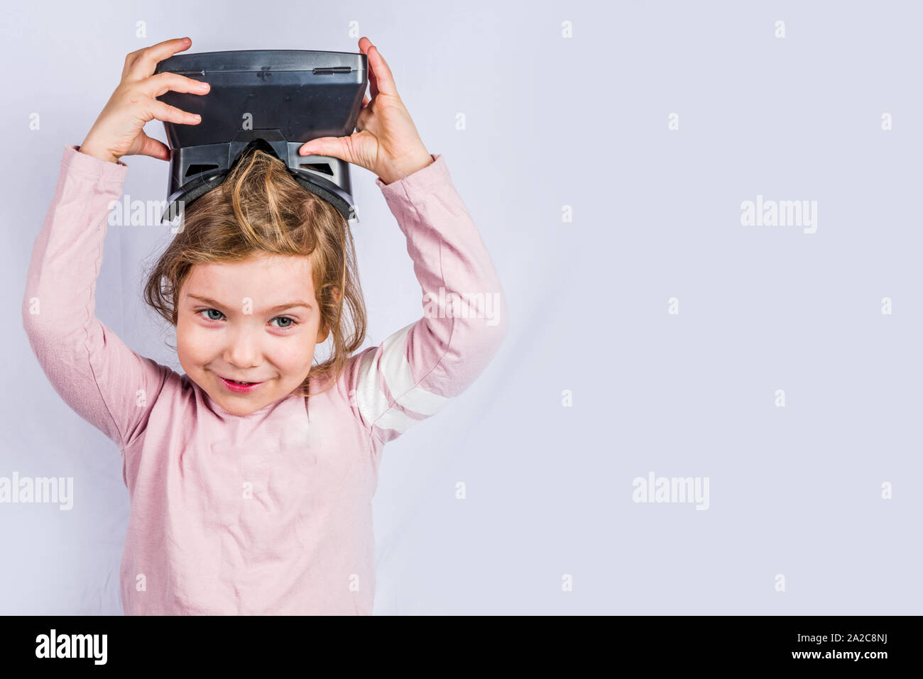 Happy little girl with virtual reality headset glasses. Innovation and ...