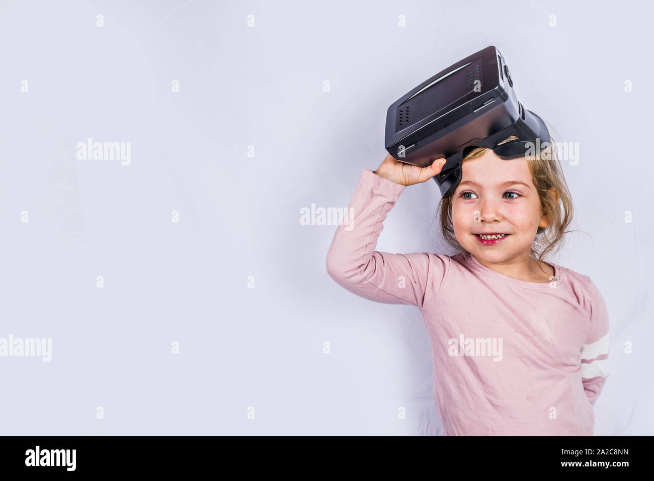 Happy little girl with virtual reality headset glasses. Innovation and ...