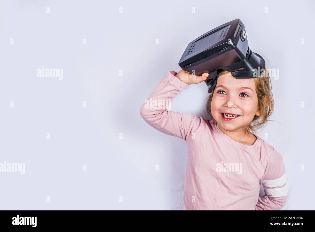 Happy little girl with virtual reality headset glasses. Innovation and ...