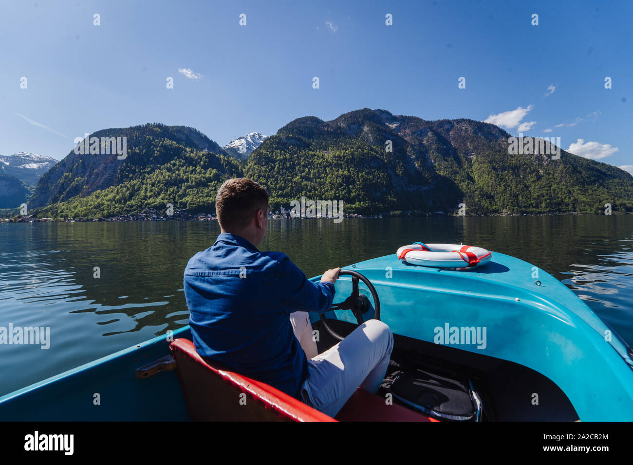 Man driving boat handsome hi-res stock photography and images - Alamy