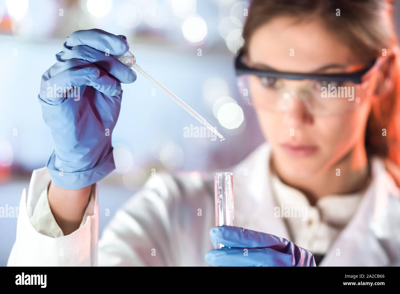 Young scientist pipetting in life science laboratory Stock Photo - Alamy
