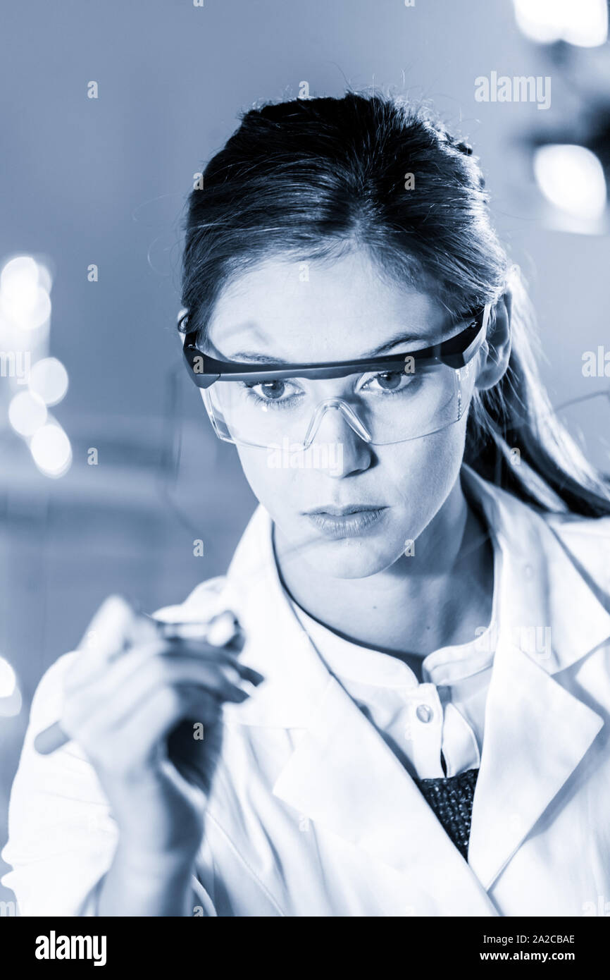 Portrait of a confident female researcher in life science laboratory ...