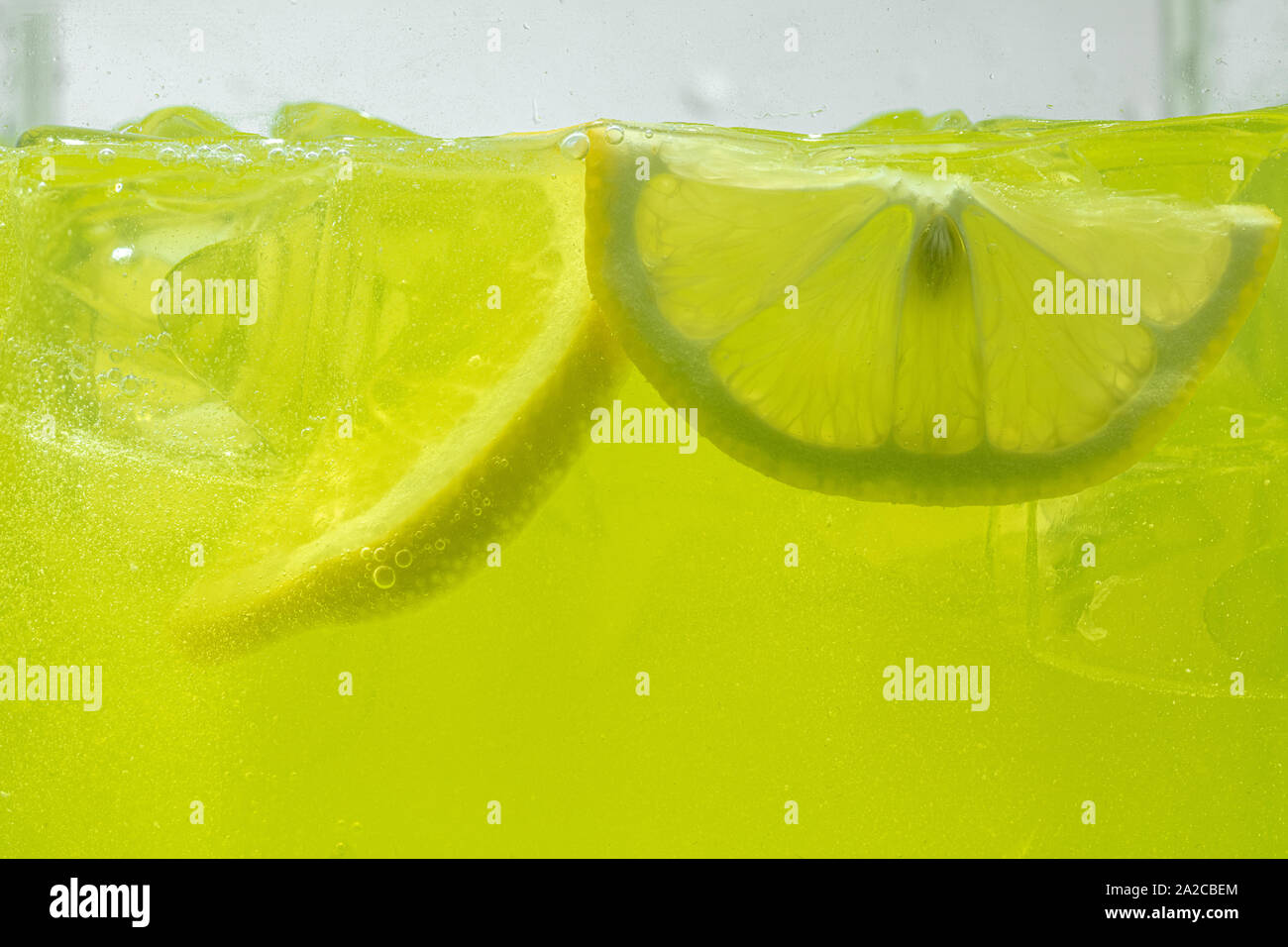 Close up view of the lemon slices in lemonade background. Texture of ...