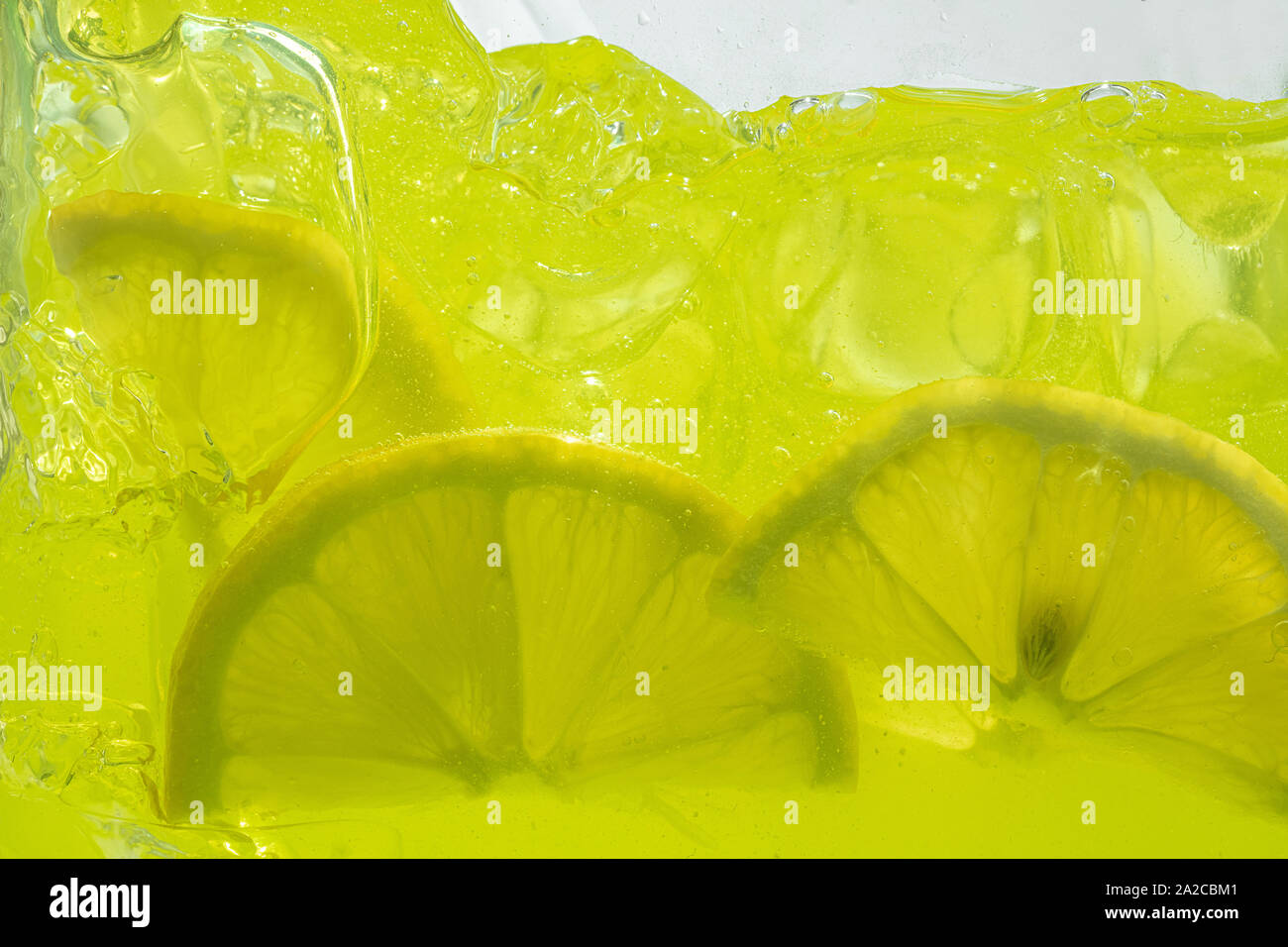 Close up view of the lemon slices in lemonade background. Texture of ...