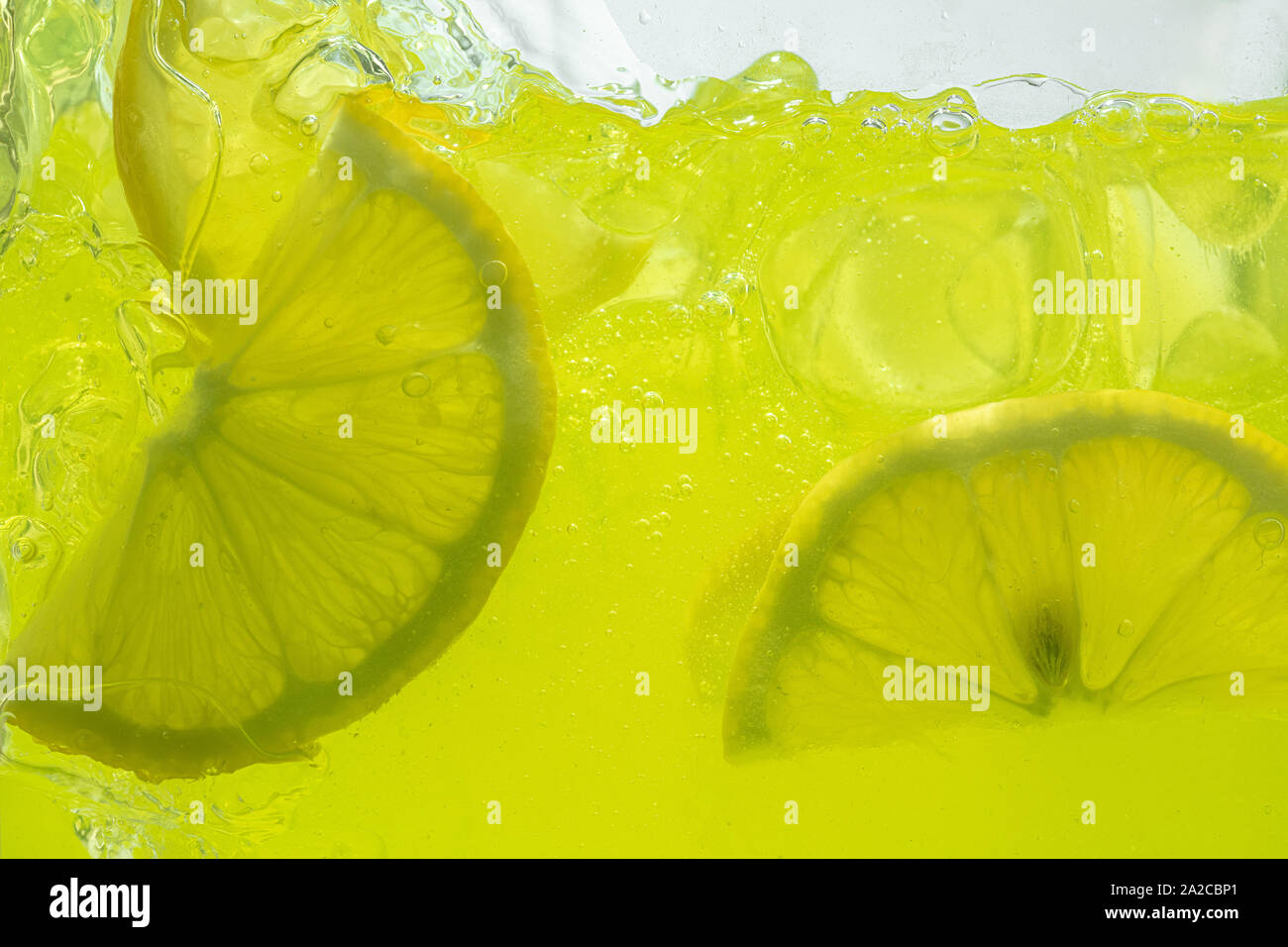 Close up view of the lemon slices in lemonade background. Texture of ...