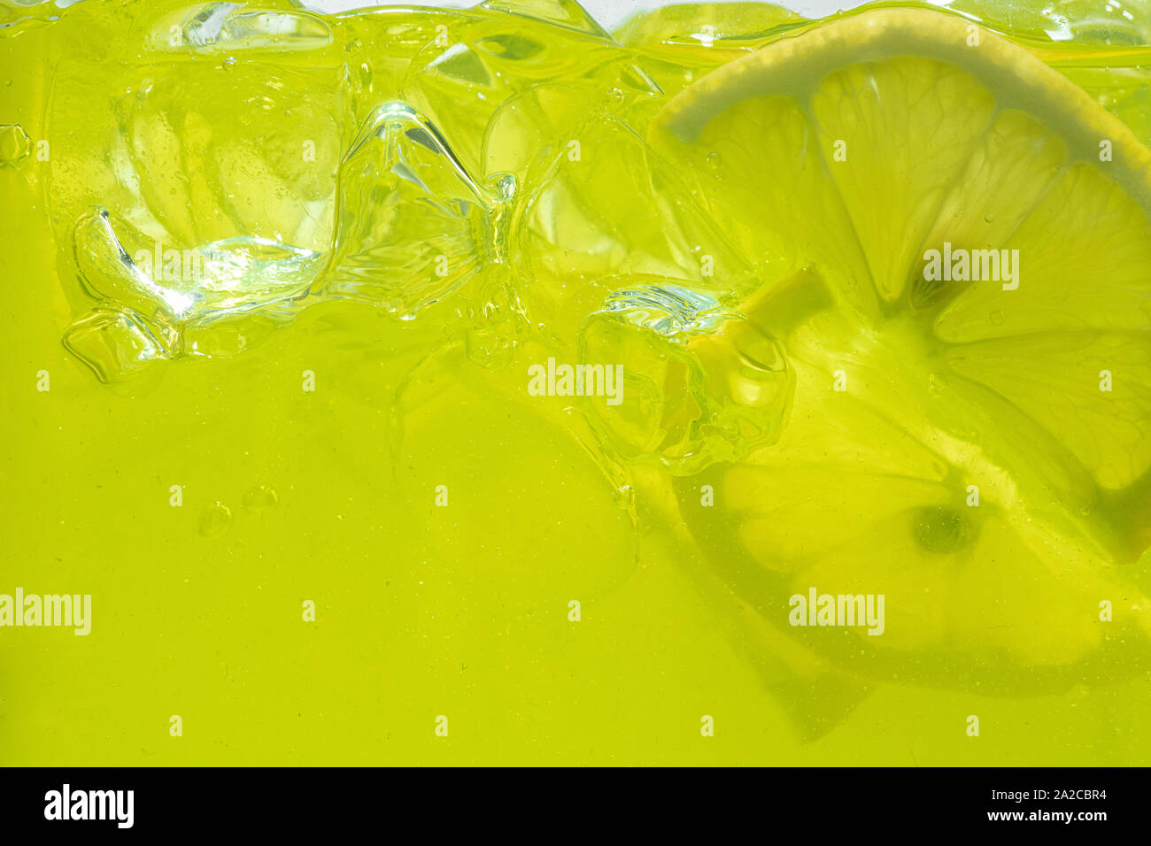 Close up view of the lemon slices in lemonade background. Texture of ...