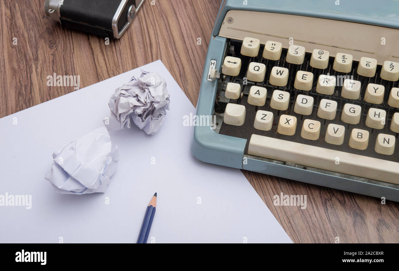 Old manual typewriter on wooden background and crumpled papers Stock ...