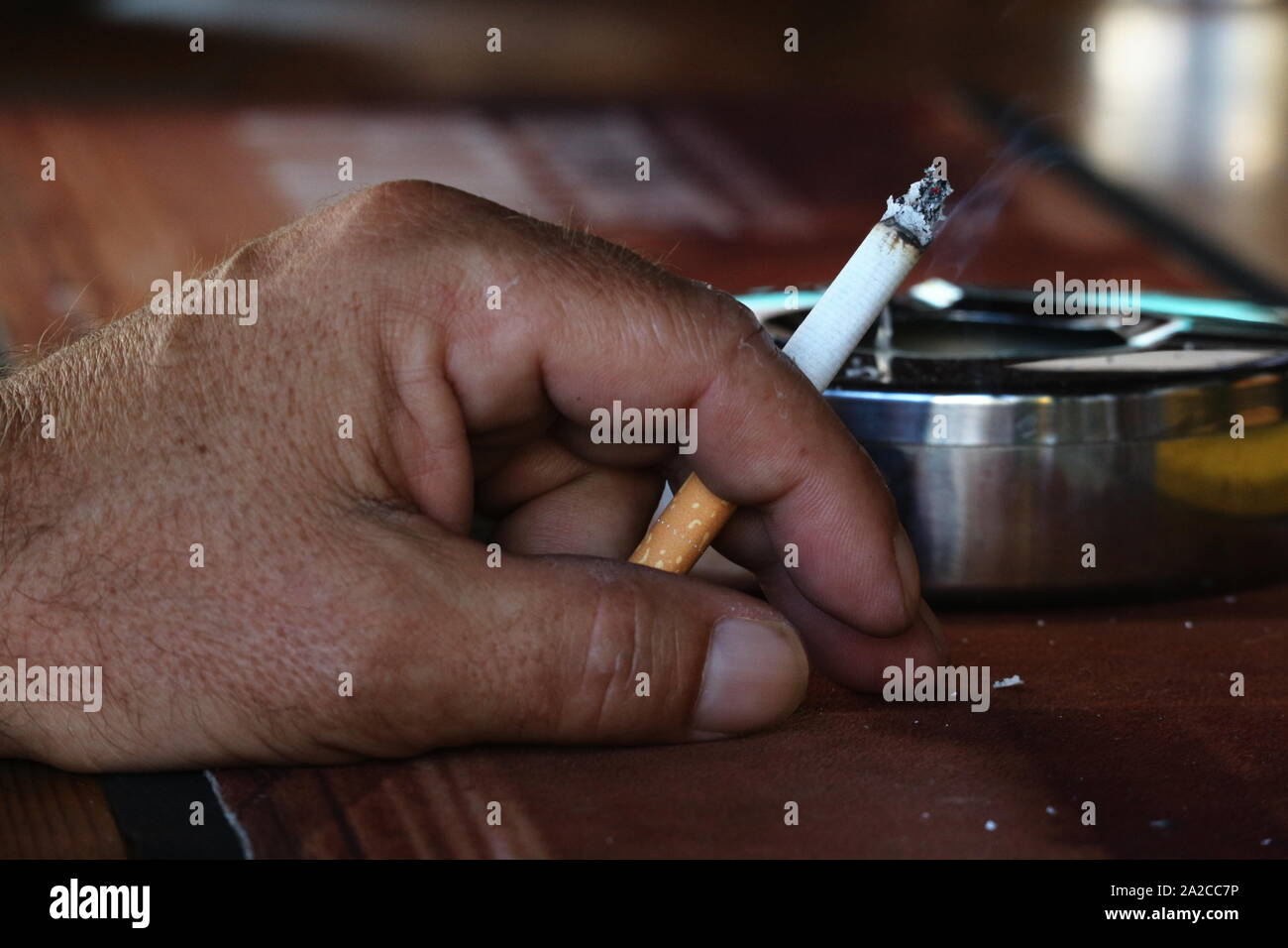 Man Smoking Lit Cigarette High Resolution Stock Photography and Images ...