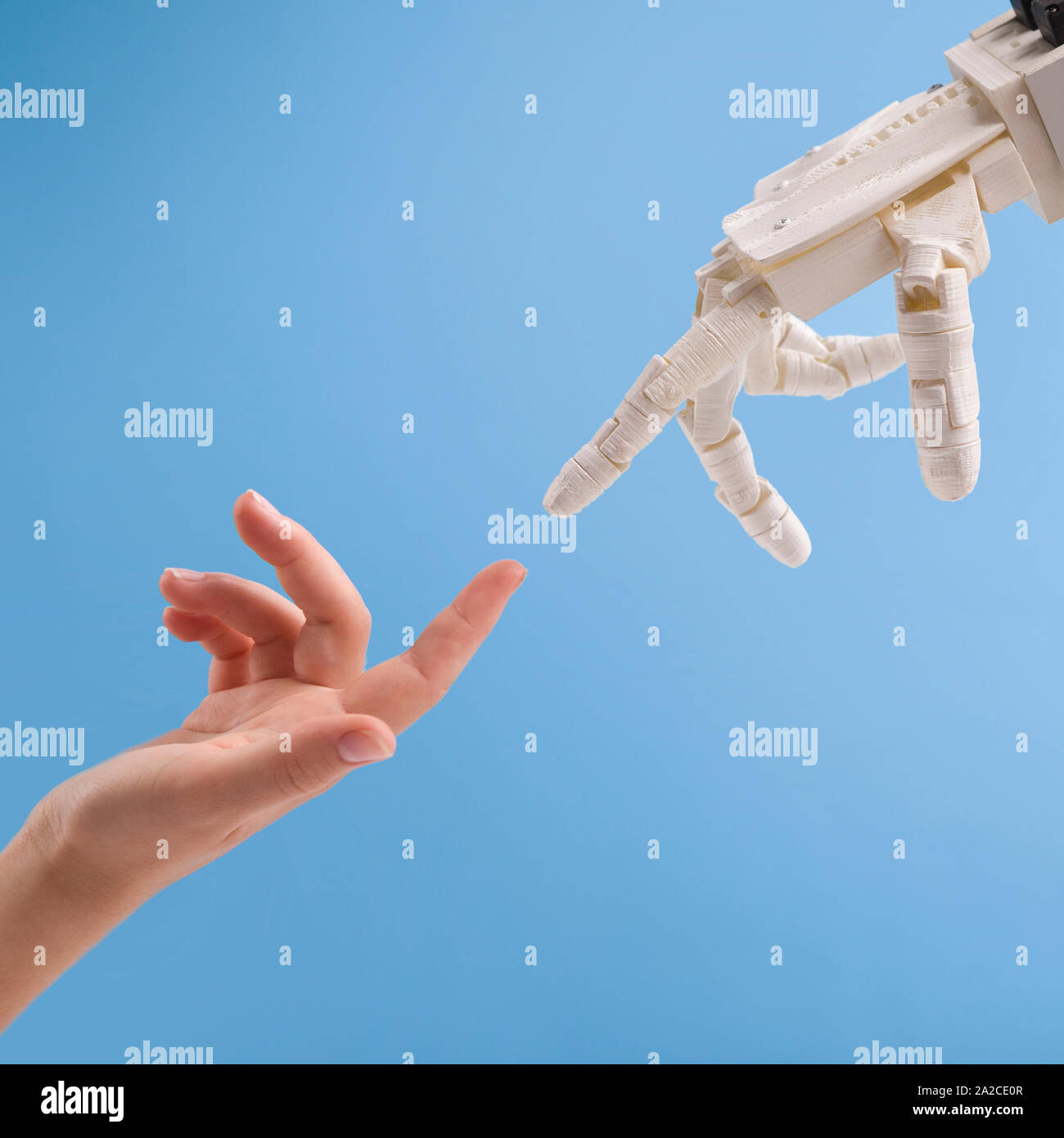 Female and robot hands reaching to each other on blue background Stock ...