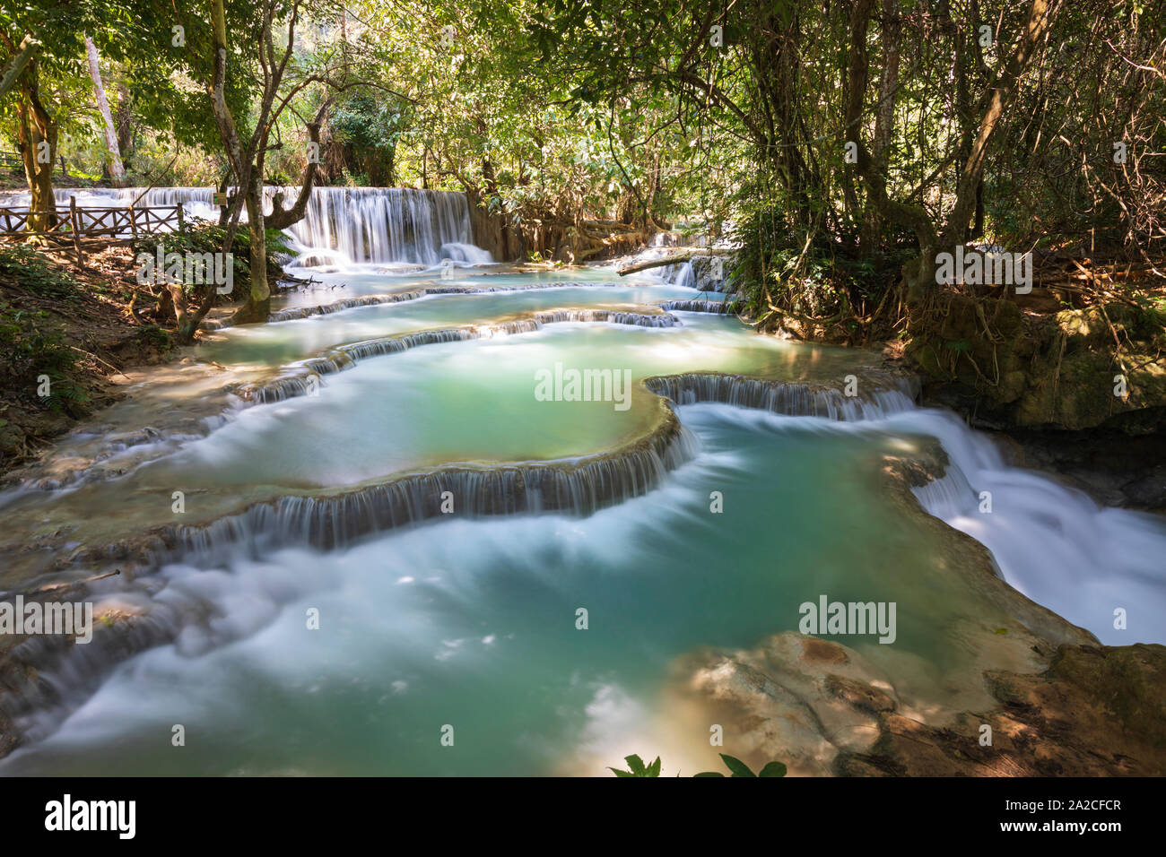 Waterfalls and limestone formations with water cascading into turquoise ...