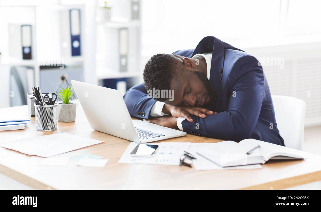 Tired black businessman sleeping in his office Stock Photo - Alamy