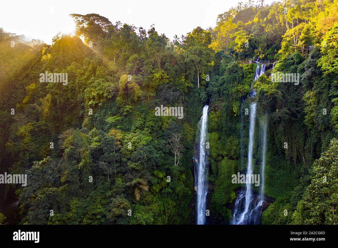 Huge water fall iin dense tropical rainforest on the island of Bali ...