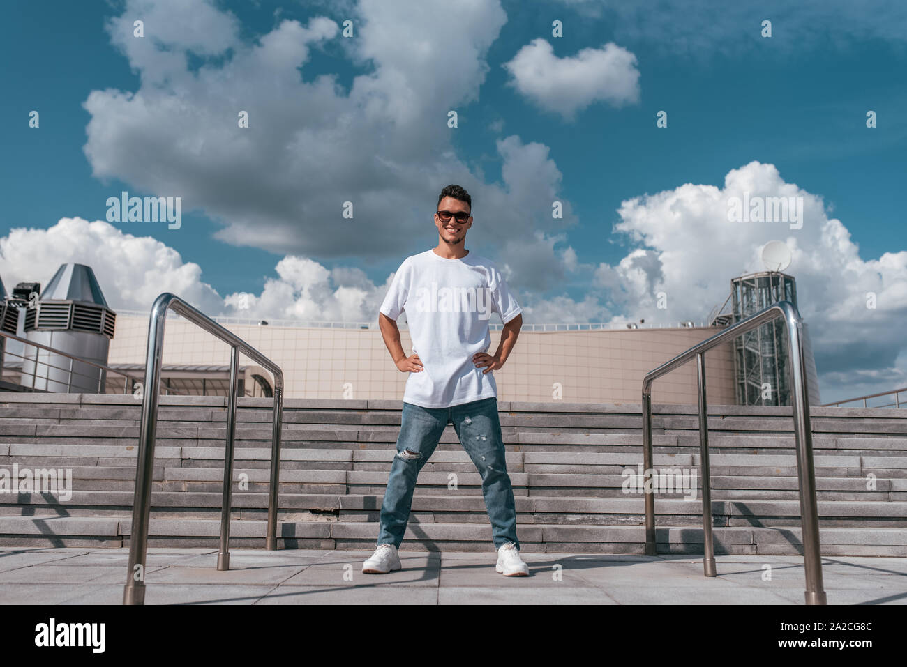 Male athlete, guy dancer in the summer in city. Standing in a pose ...