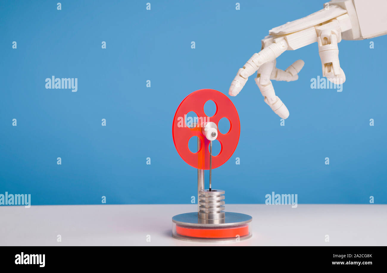 Robot hand touching red plastic gear, blue background Stock Photo - Alamy