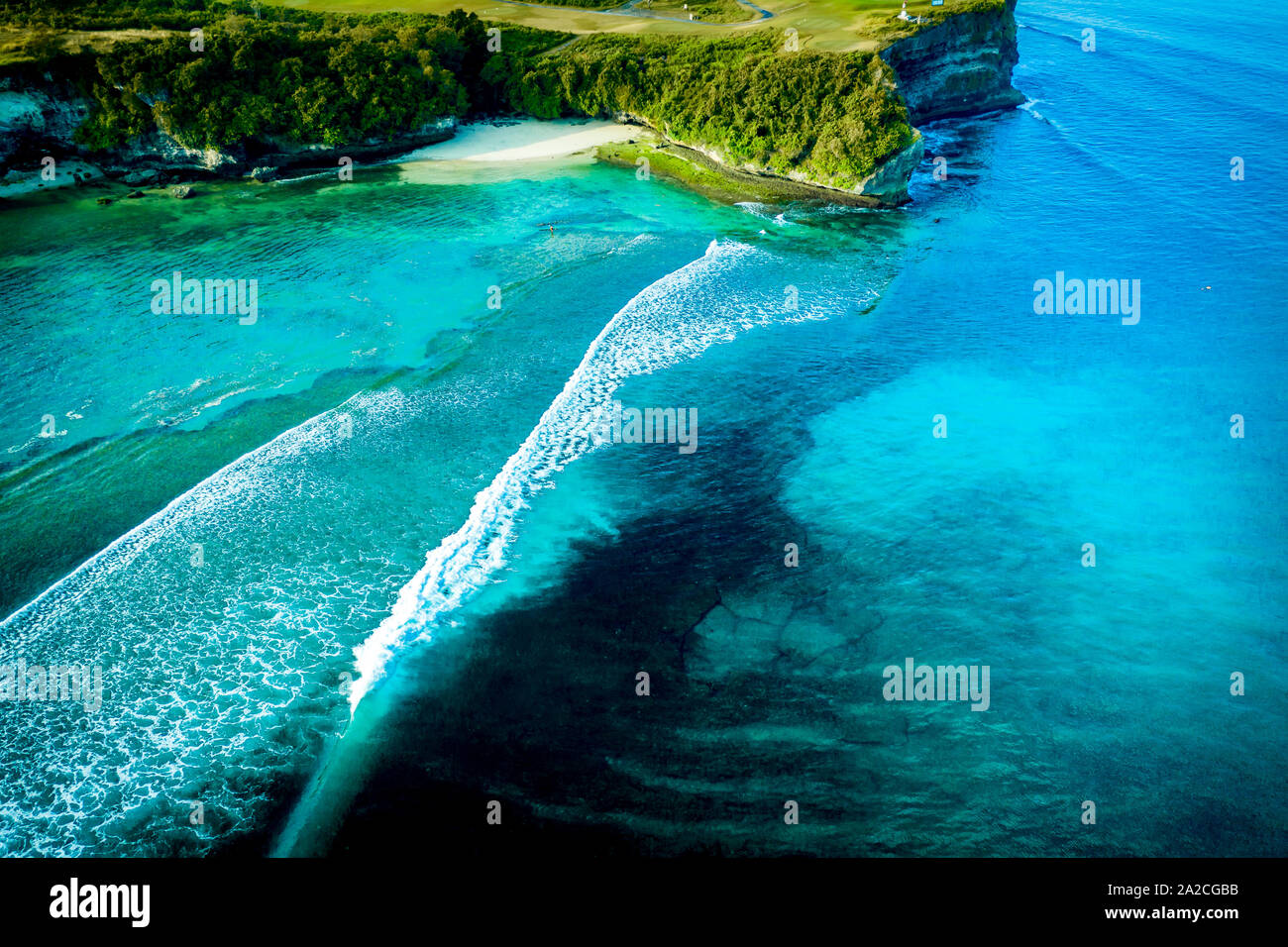 Aerial view of a tropical cove with large waves breaking Stock Photo ...