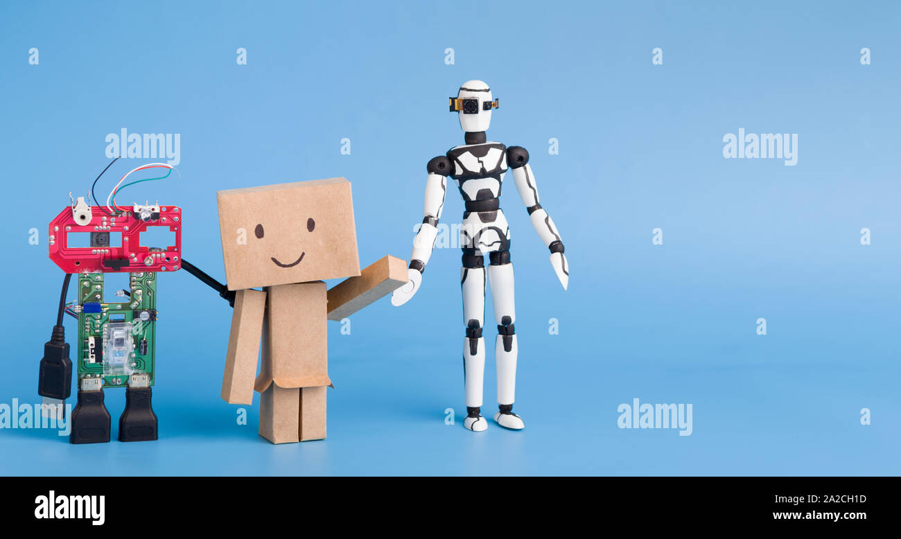 Three robots made with different materials on blue background, free ...