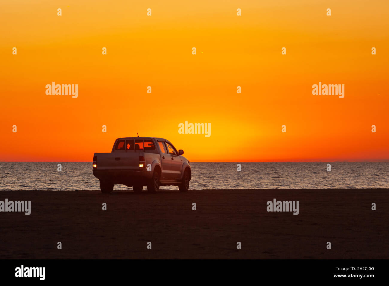 Pick-up truck parked in front of Black Sea at beautiful sunset. Nature ...