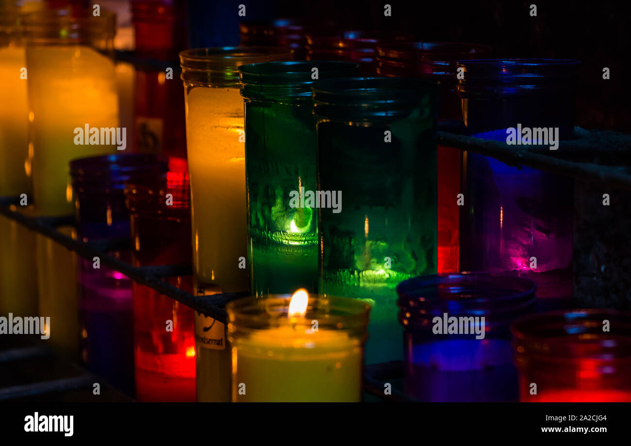 A picture of a group of colorful lit candles Stock Photo - Alamy