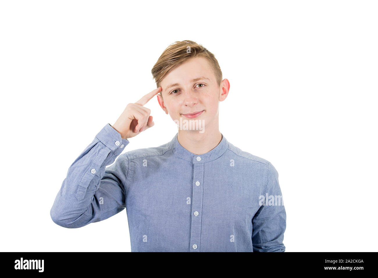 Portrait smart teenage boy pointing forefinger to his head showing ...