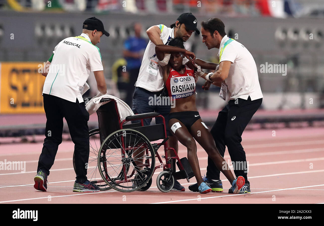Bahrain’s Tigist Gashaw is helped off the track by medical officials ...
