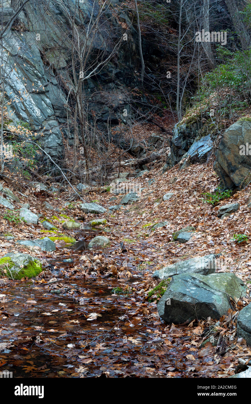 Water draining from a series of rocky cliffs where the other end of a ...